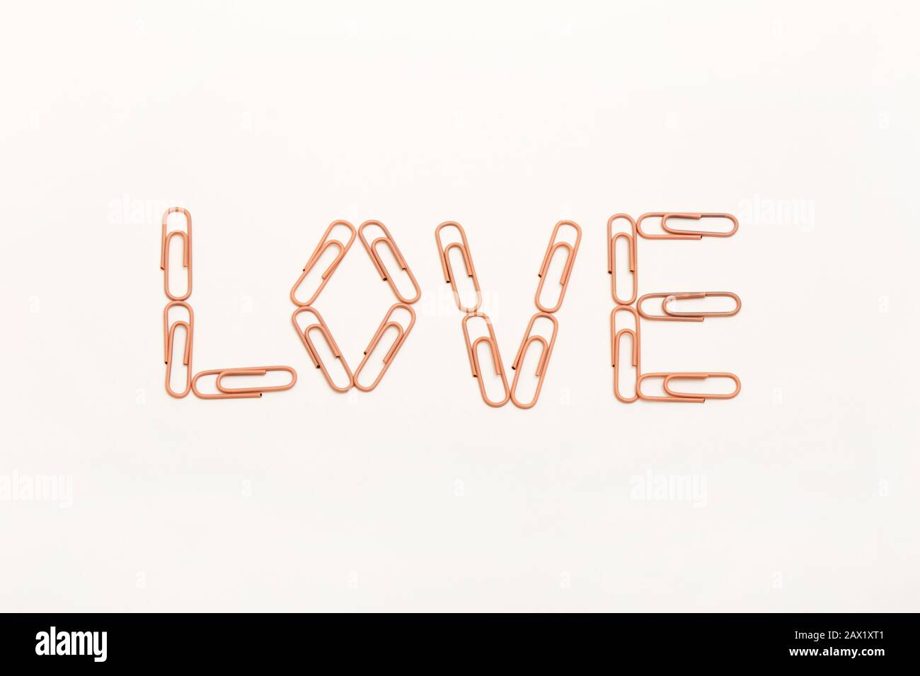 love shaped paperclips on white background Stock Photo - Alamy