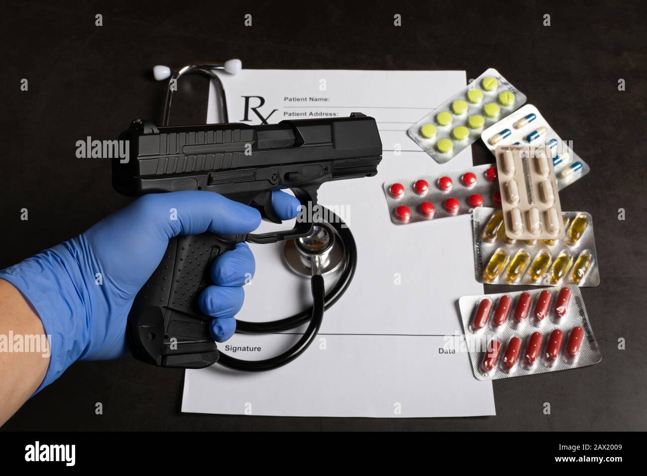 Doctor's hand pointing a gun over medical prescription Stock Photo - Alamy