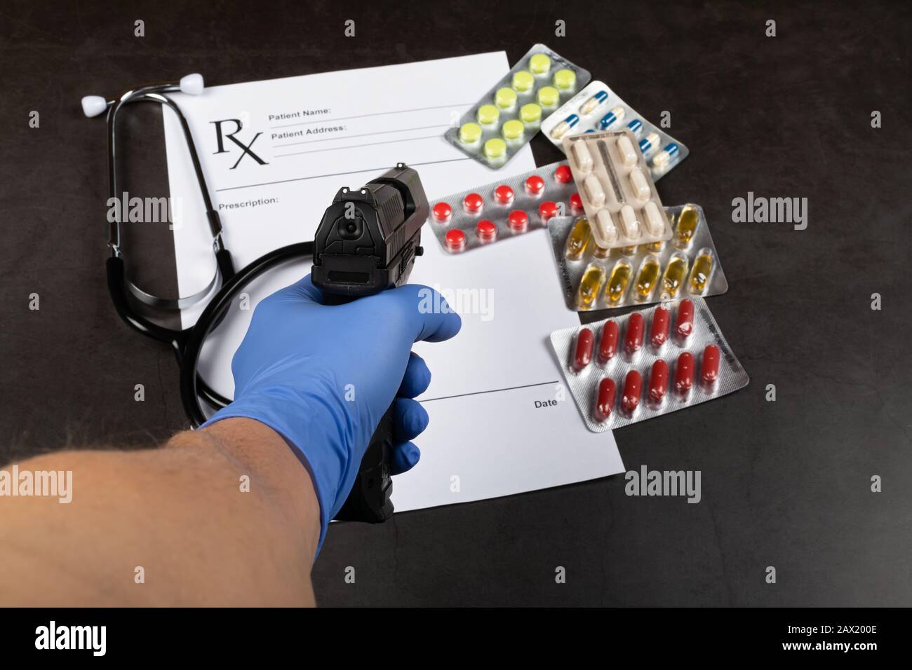 Doctor's hand pointing a gun over medical prescription Stock Photo - Alamy