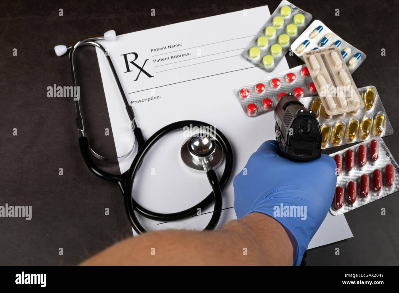 Doctor's hand pointing a gun over medical prescription Stock Photo - Alamy