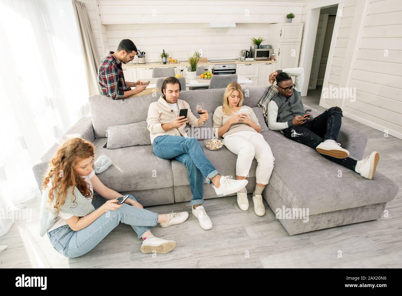 Horizontal shot of modern young people watching something on their ...