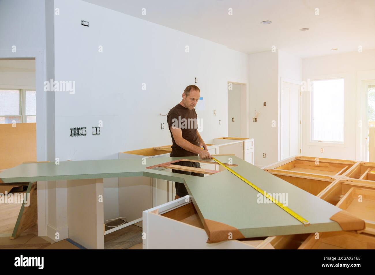 Installing laminate kitchen counter top a kitchen remodel Stock Photo ...