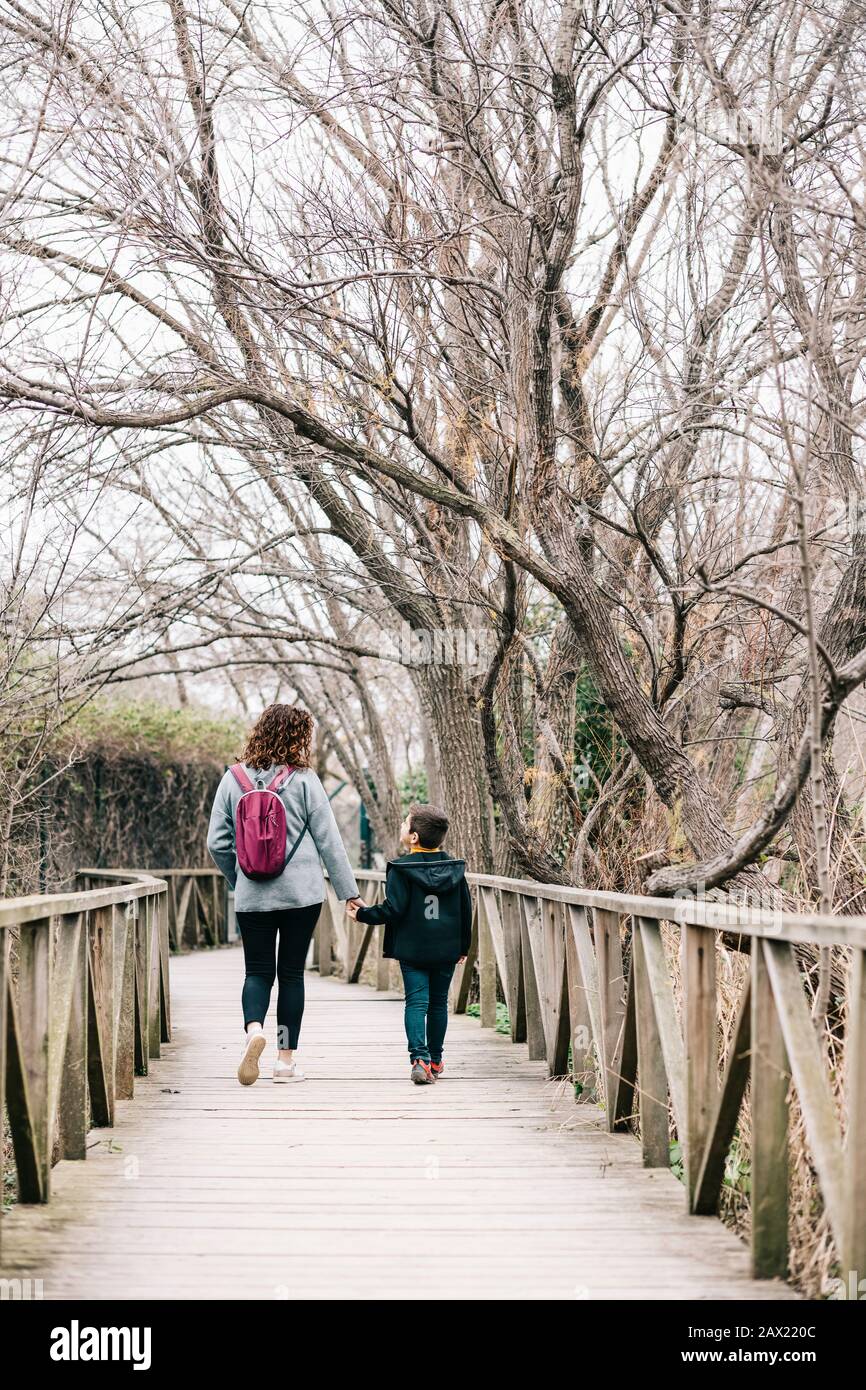 Mother and son crossing a bridge together Stock Photo - Alamy