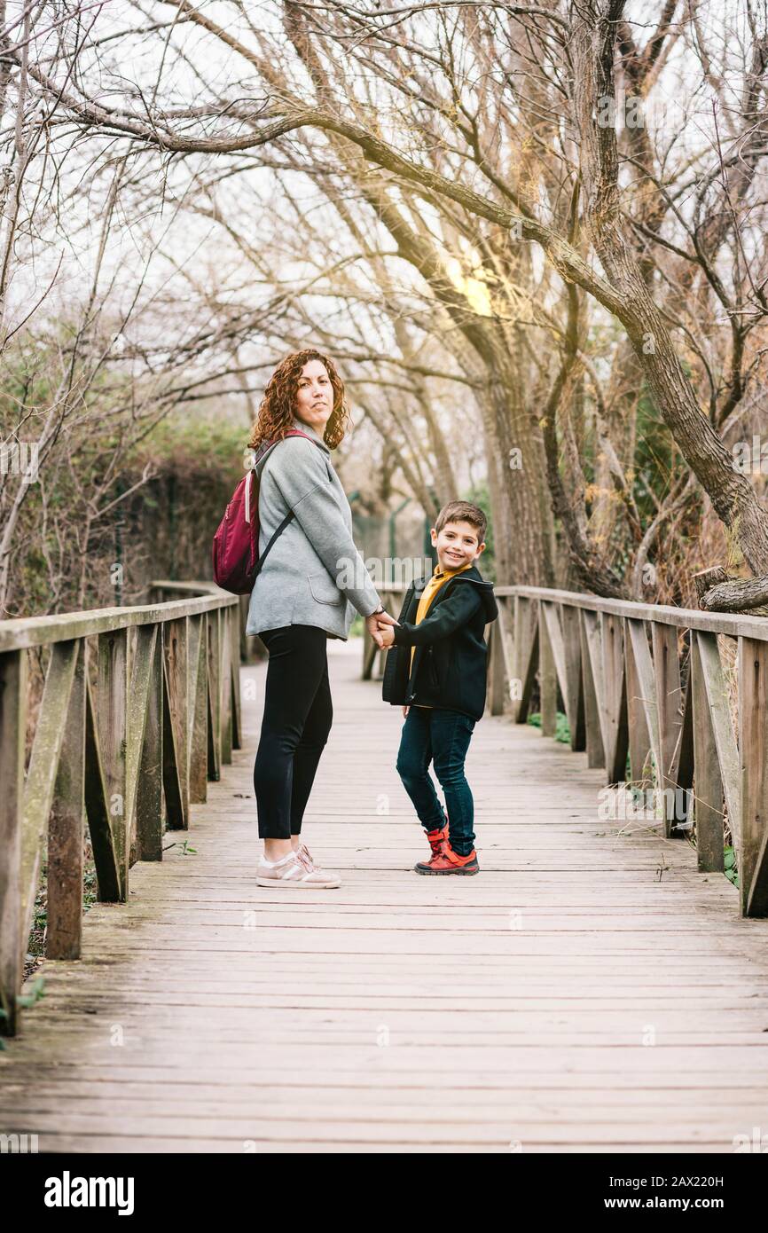 Mother and son crossing a bridge together Stock Photo - Alamy