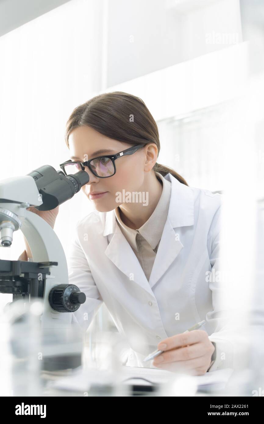 Vertical portrait young Caucasian medical scientist wearing eyeglasses ...