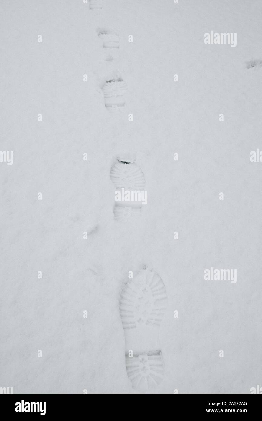 human footprints on the snow, winter path The footprint in snow and ...