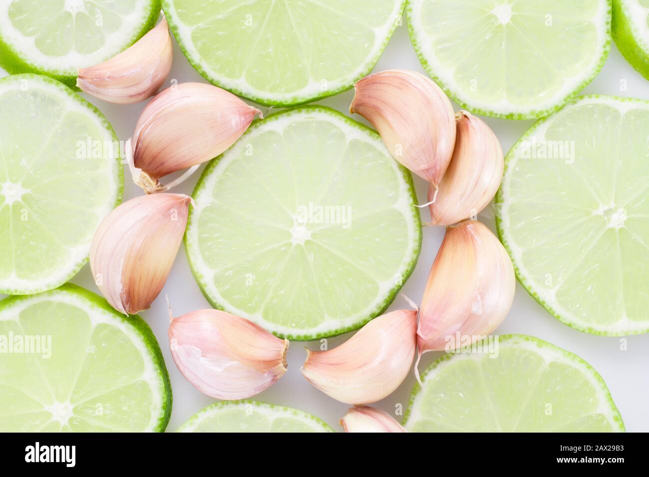 garlic and slices of lemon on white background Stock Photo - Alamy