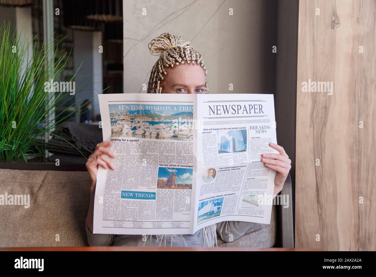 Hiding behind newspaper hi-res stock photography and images - Alamy