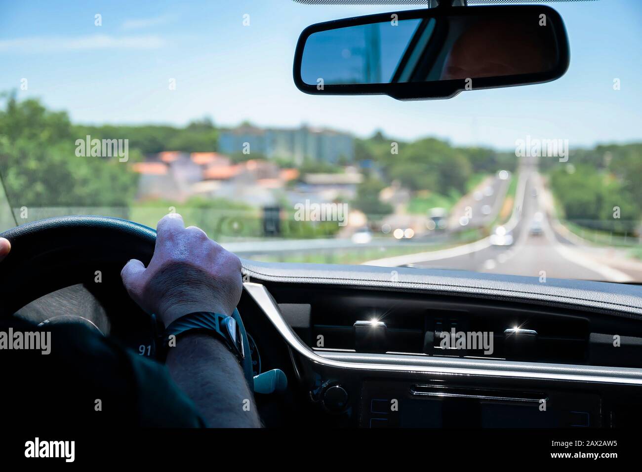Driving a car on a long highway. View through the inside of a car ...