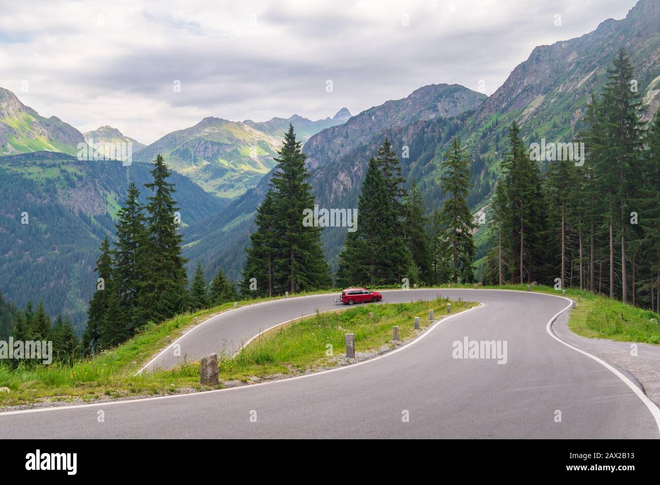 Silvretta High Alpine Road. Red car on a serpentine of mountain tourist ...