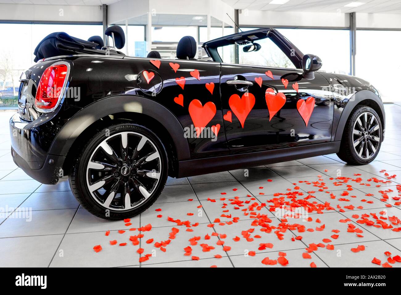 a mini cooper cabrio decorated with red hearts for Valentine's Day ...