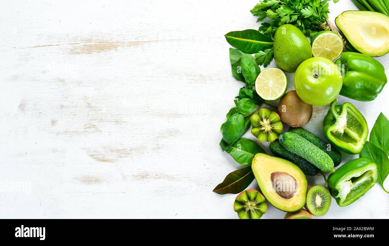 Fresh organic green fruits and vegetables. Avocado, kiwi, onion, lime ...