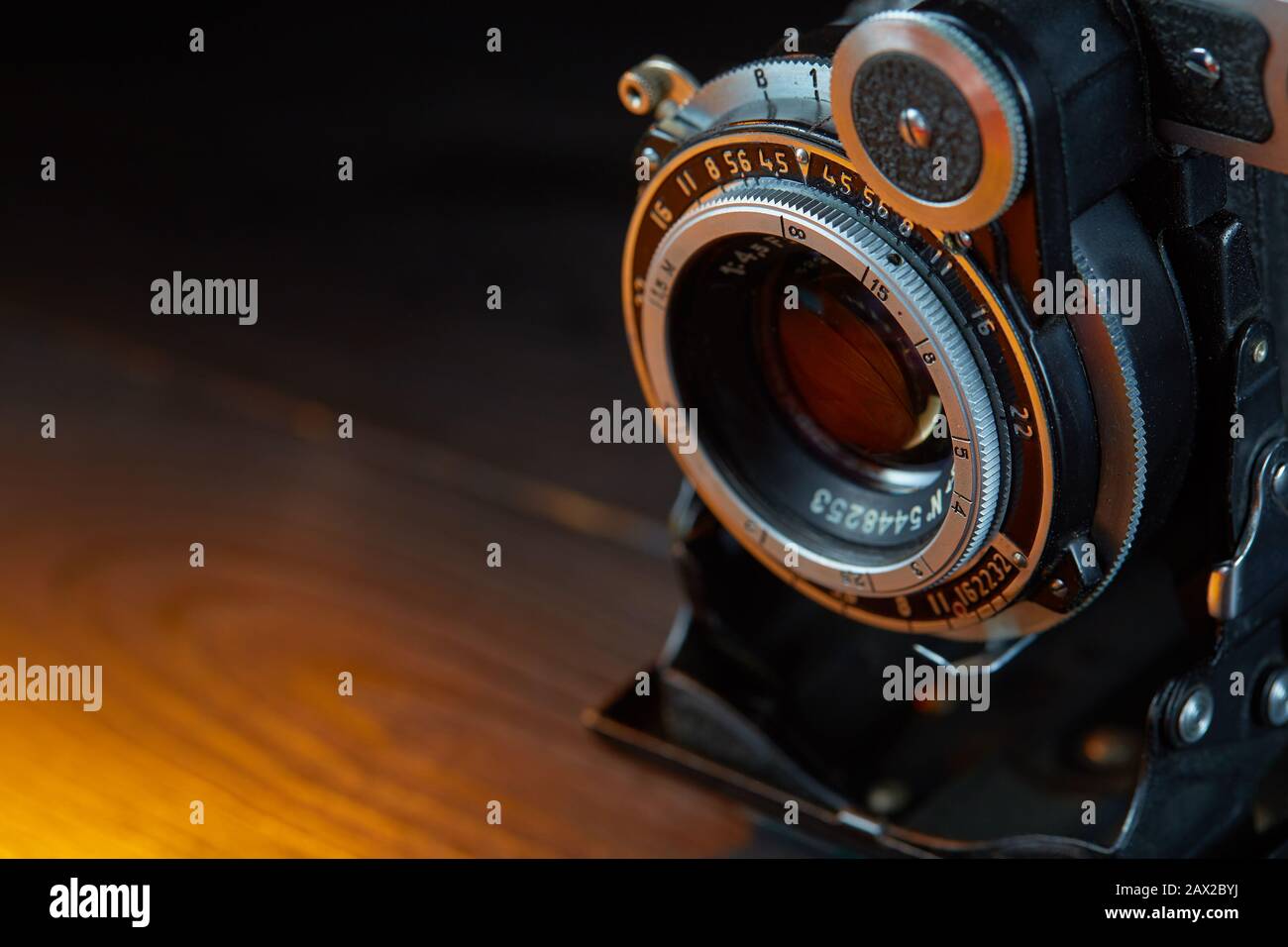 Old vintage camera on the wooden table. Cinematic style Stock Photo - Alamy