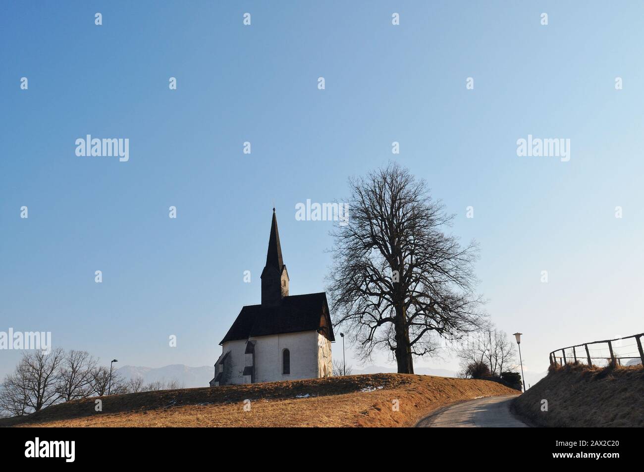 Small church with beautiful tree on the hill Stock Photo - Alamy