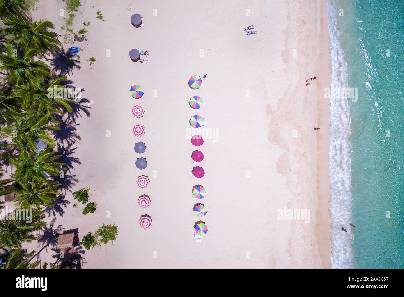 Top view of beach with colorful umbrellas and people bathing in the sun ...