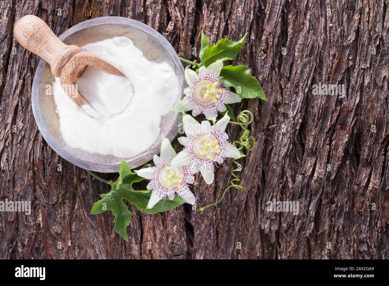 Hydrolyzed collagen and passion flower on wooden background Stock Photo ...