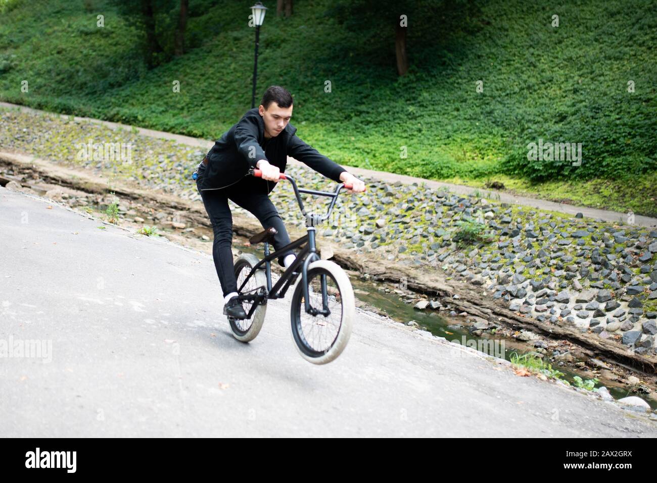 The guy on the BMX is trying to raise the front wheel Stock Photo - Alamy