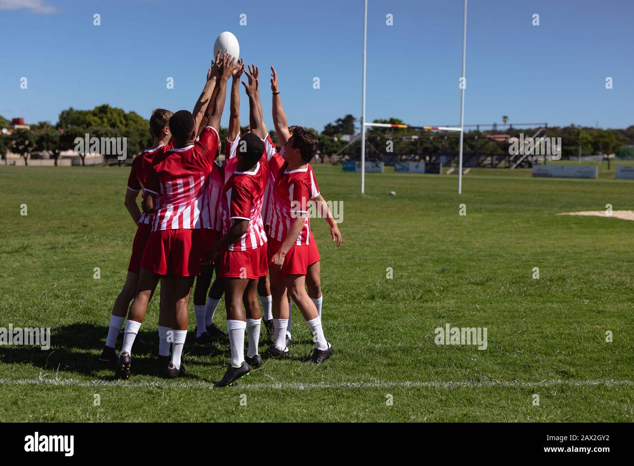 Rugby team happy in the field Stock Photo - Alamy