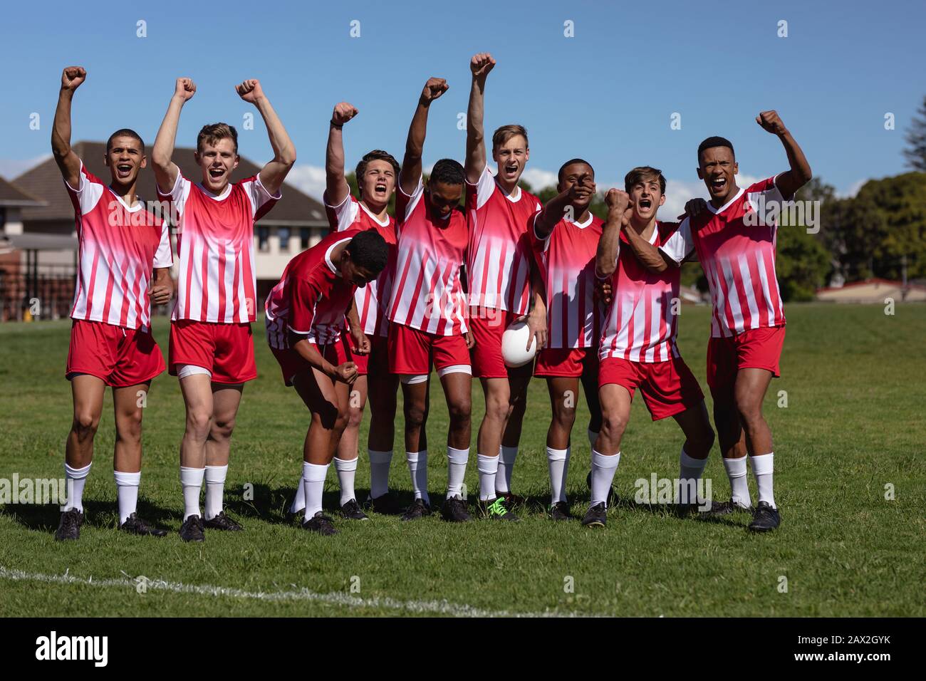 Rugby team happy in the field Stock Photo - Alamy