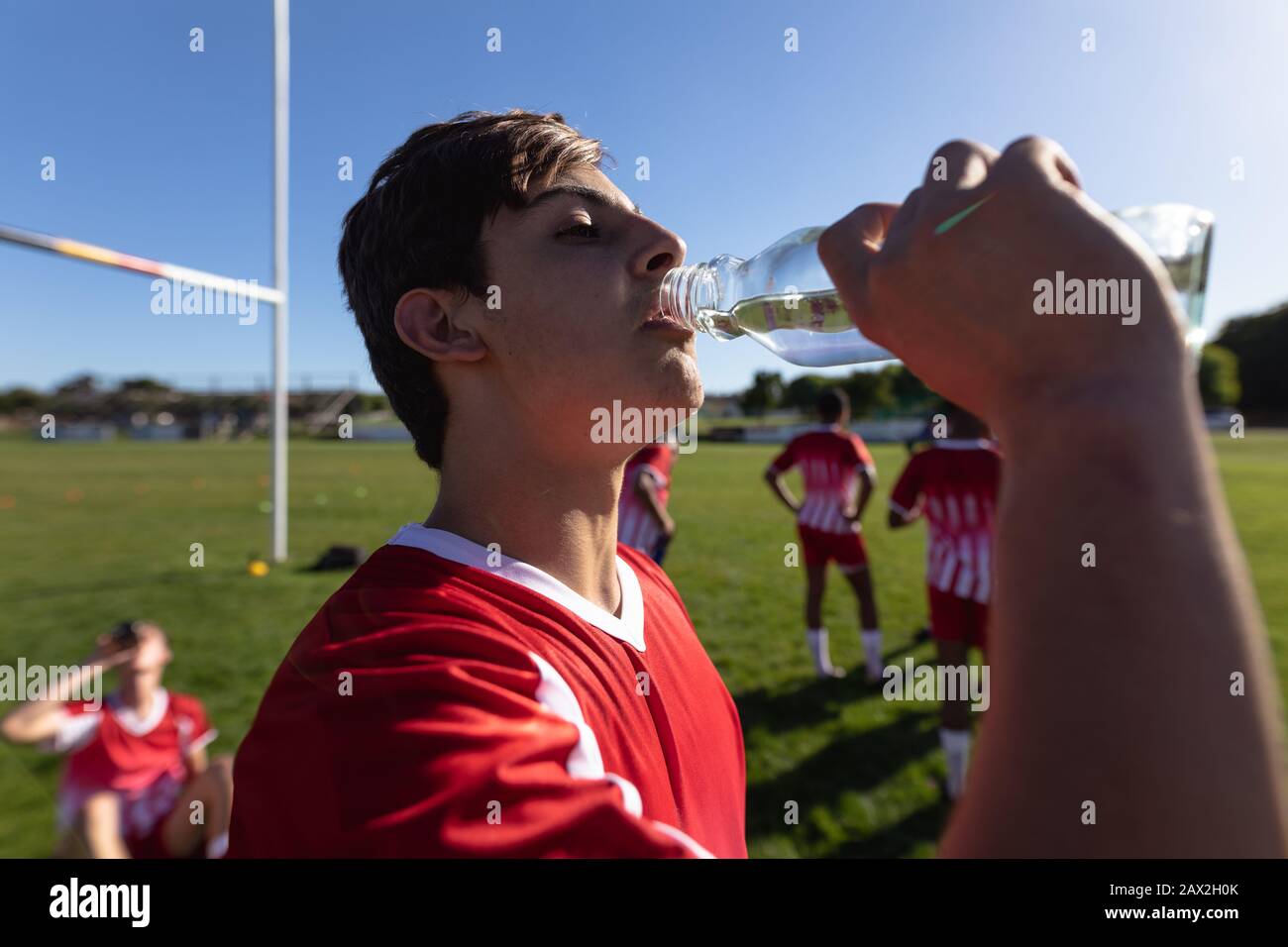 Rugby player drinking water Stock Photo - Alamy