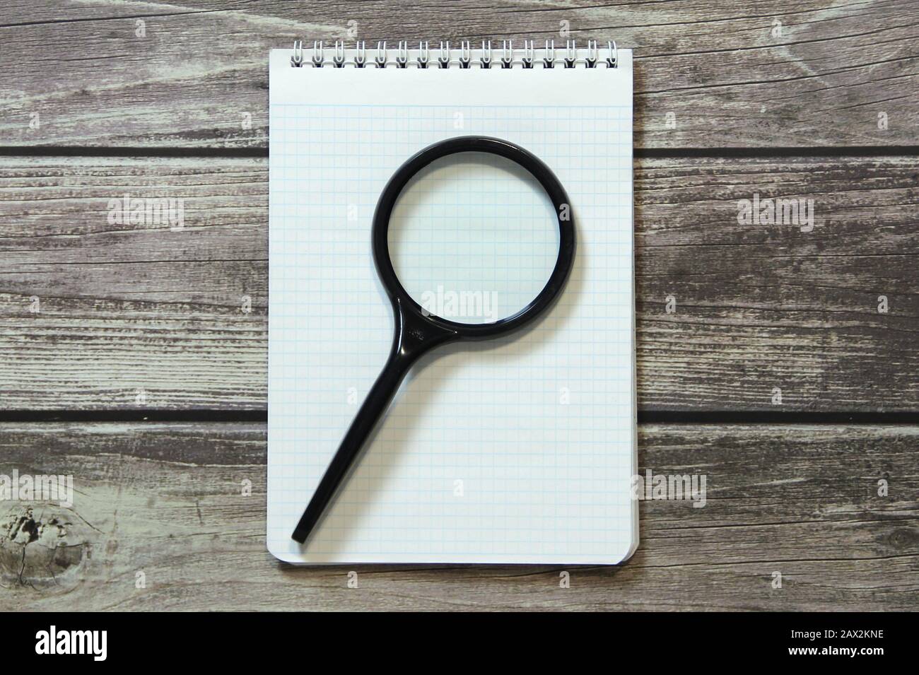 Notepad with a blank white sheet in a checker paper lies with ...