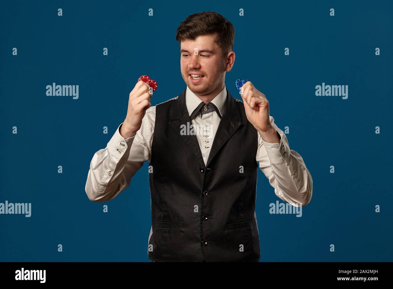 Good-looking male, noob in poker, in black vest and white shirt ...
