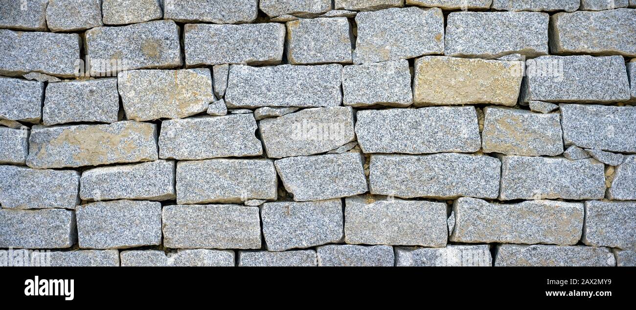 stone wall made from dry piled up broken granite stones Stock Photo - Alamy