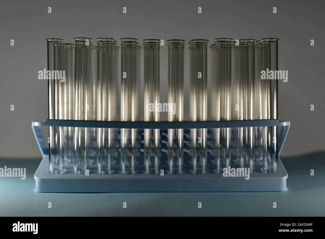 The tray with test tubes in the shade is partially illuminated by a ...
