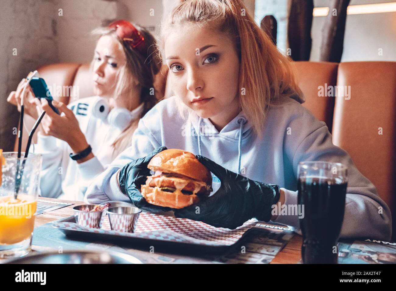 Student girl eating hamburger hi-res stock photography and images - Alamy