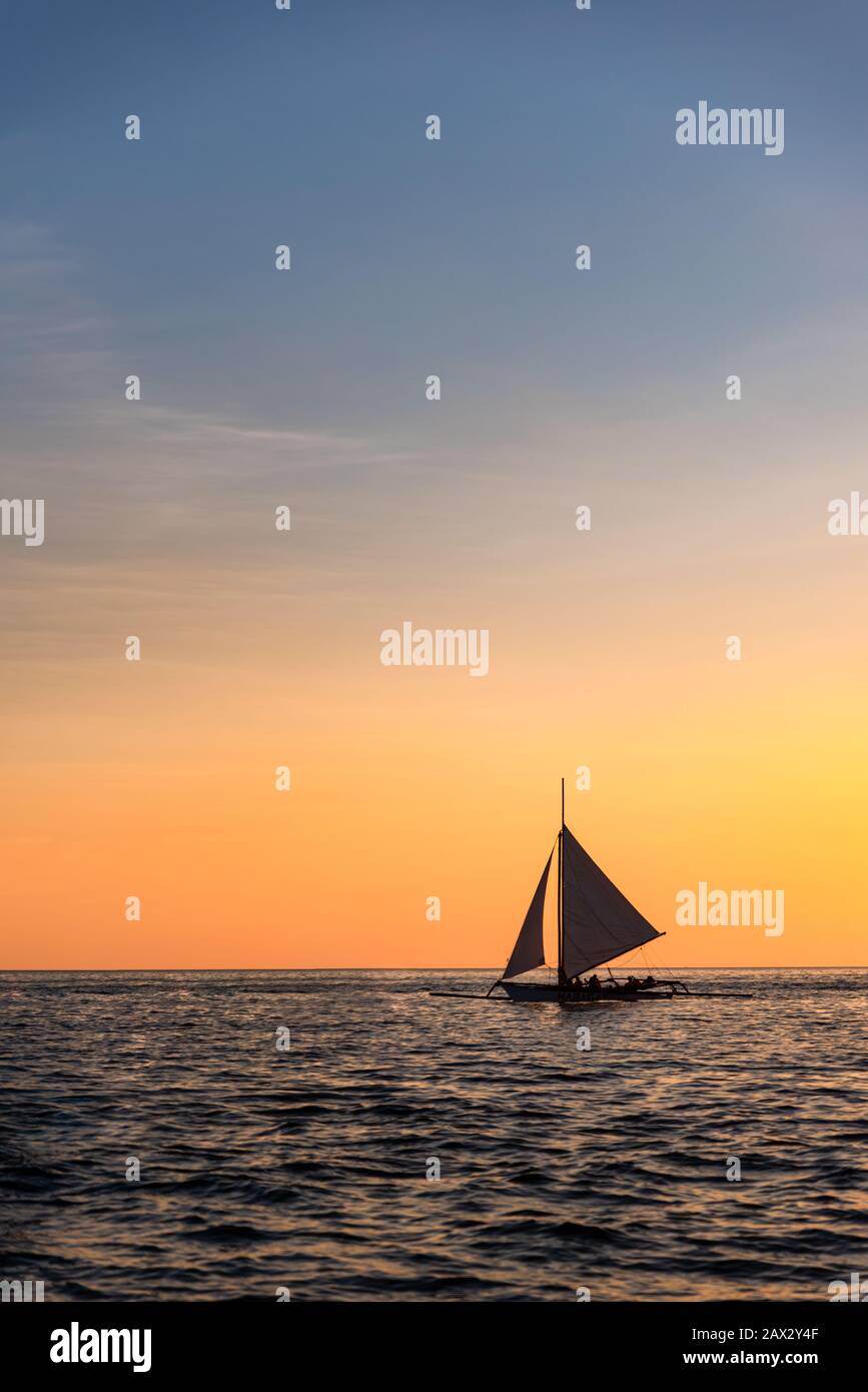 Paraw sailing at Boracay Island, Philippines at Sunset Stock Photo - Alamy