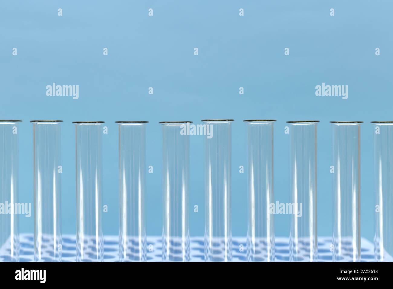 One row of horizontally constructed test tubes on a blue background ...