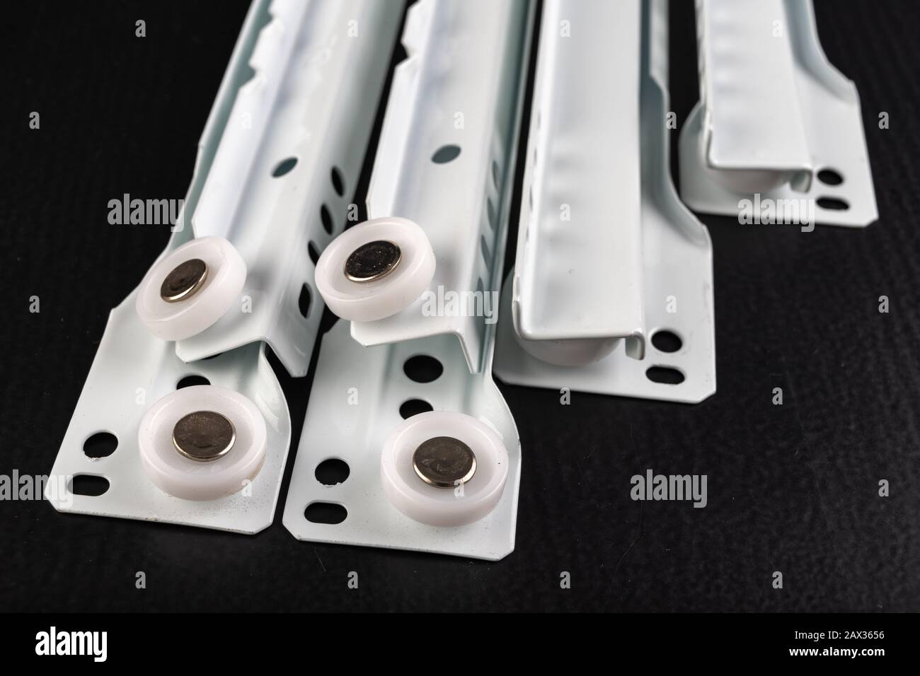 White roller guide used in carpentry. Furniture accessories on a ...