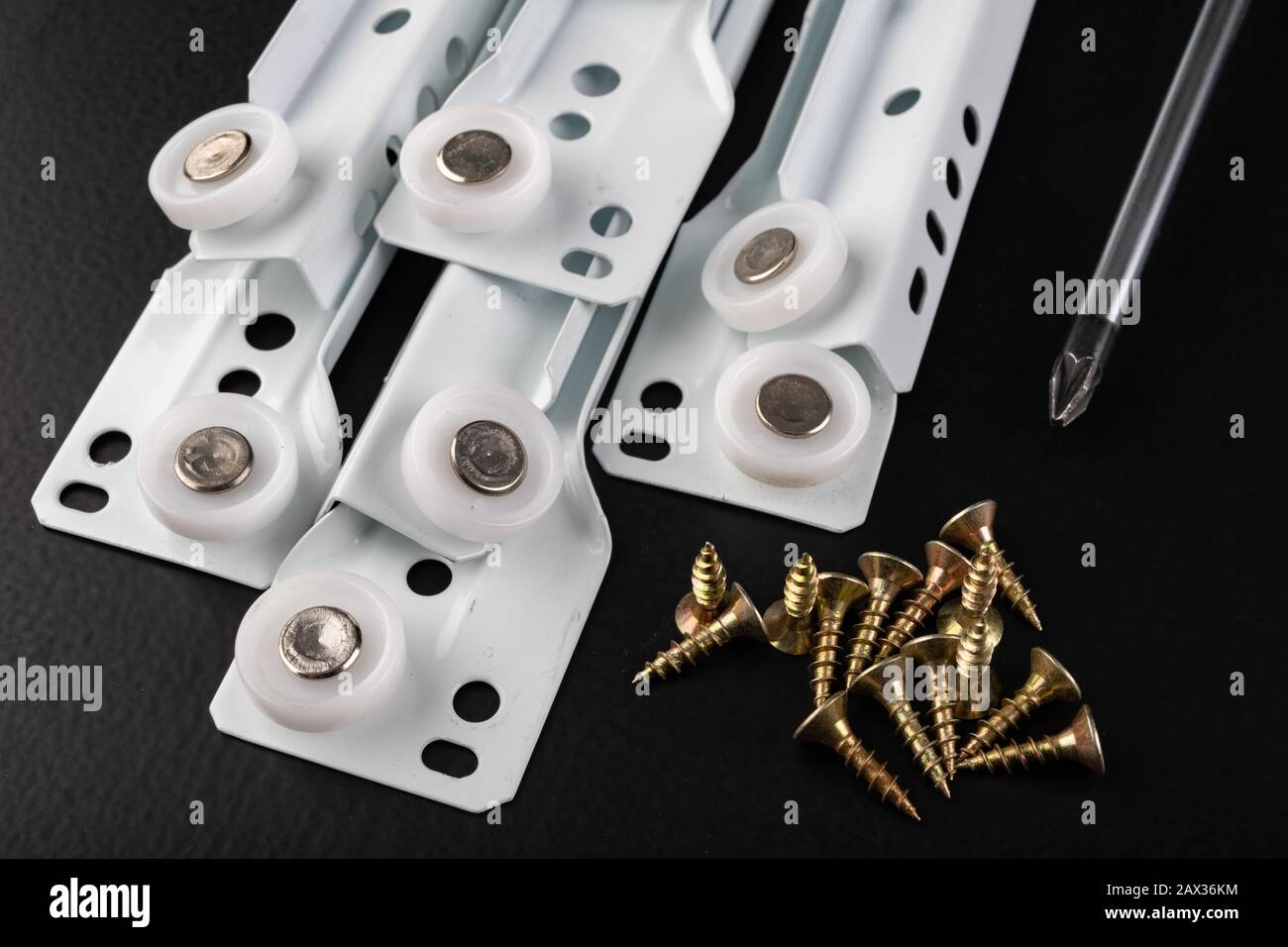 White roller guide used in carpentry. Furniture accessories on a ...