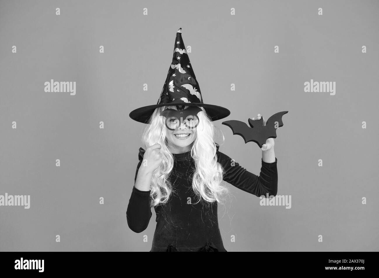 Wizard or magician. Halloween party. Photo booth props. Small girl in black witch hat. Autumn ...