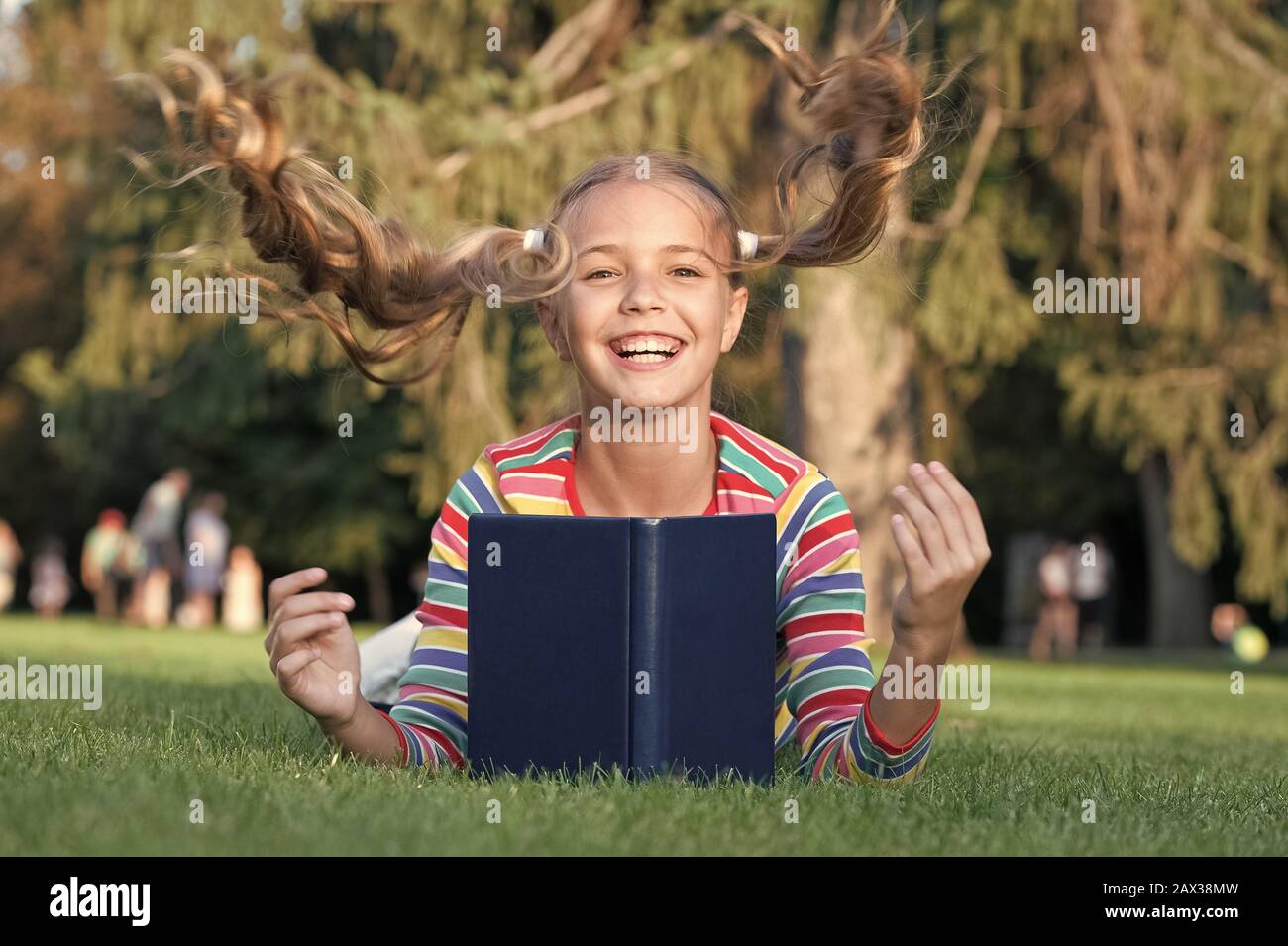 Getting your hairstyle fly. Happy child with flying hairstyle on green ...