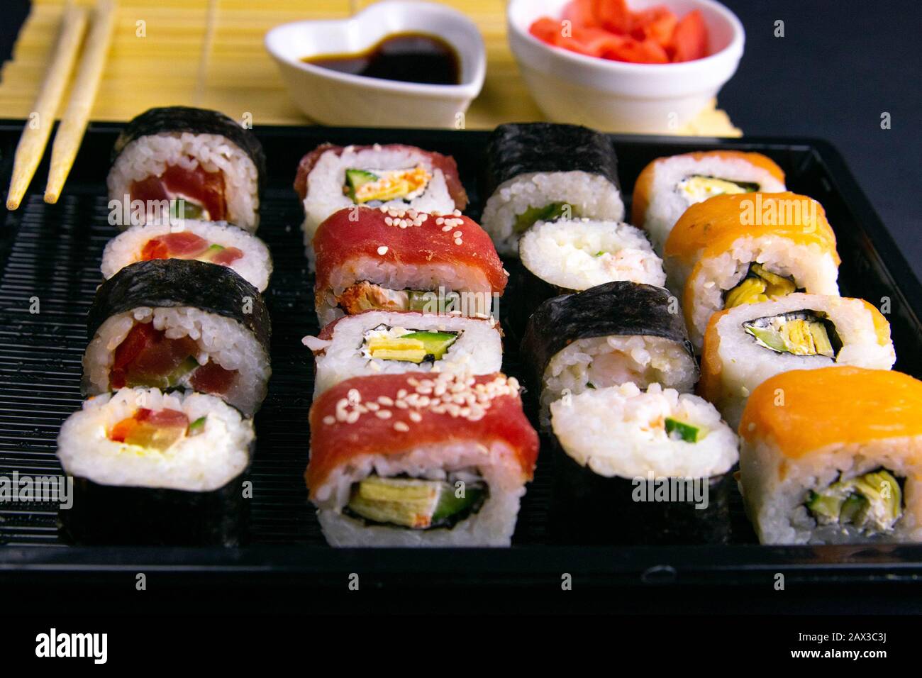 Different kinds of rolls stand on a black plate that stands on a black ...