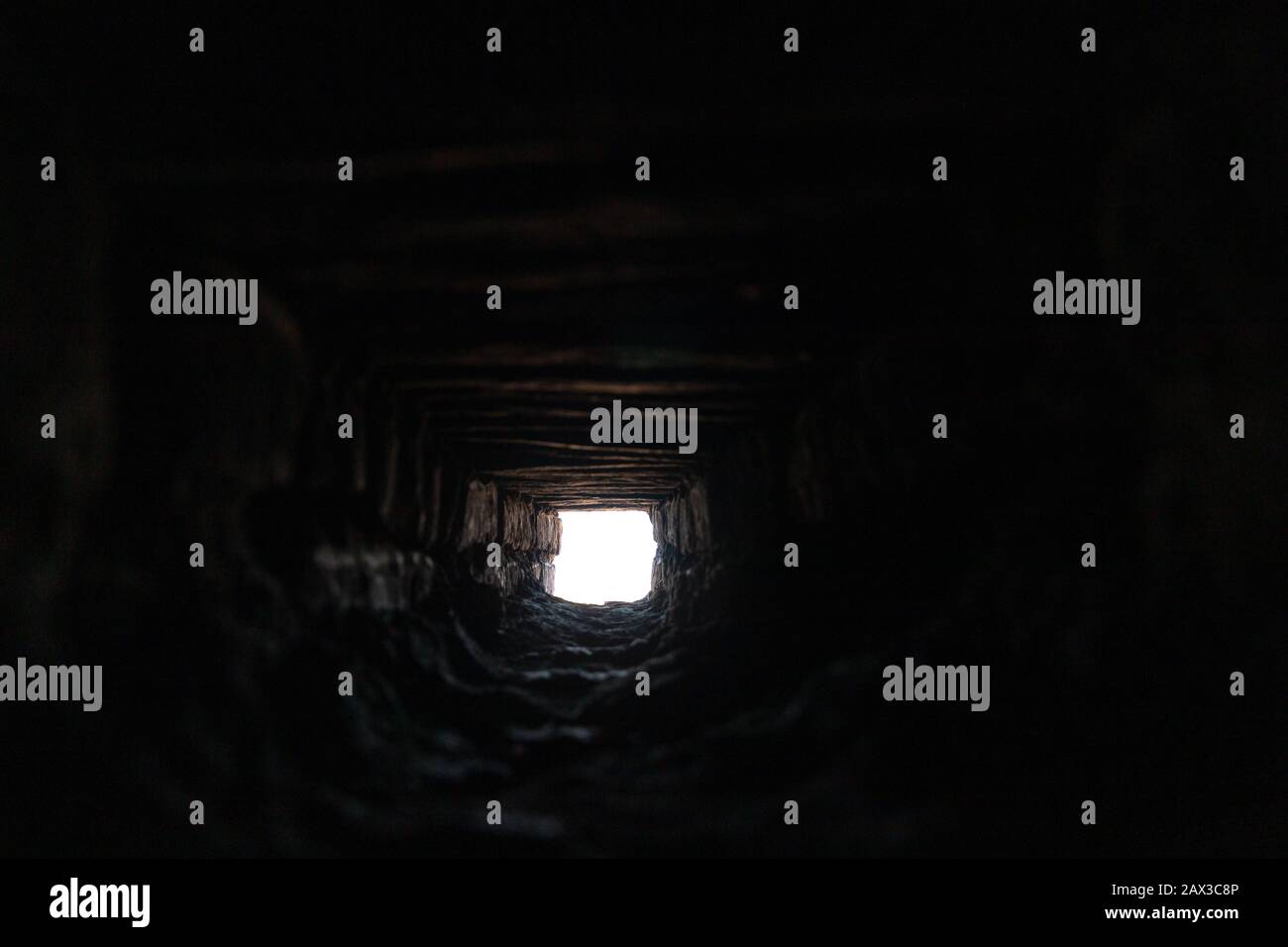 Looking through a hole through the wall from inside Asinelli Tower in ...