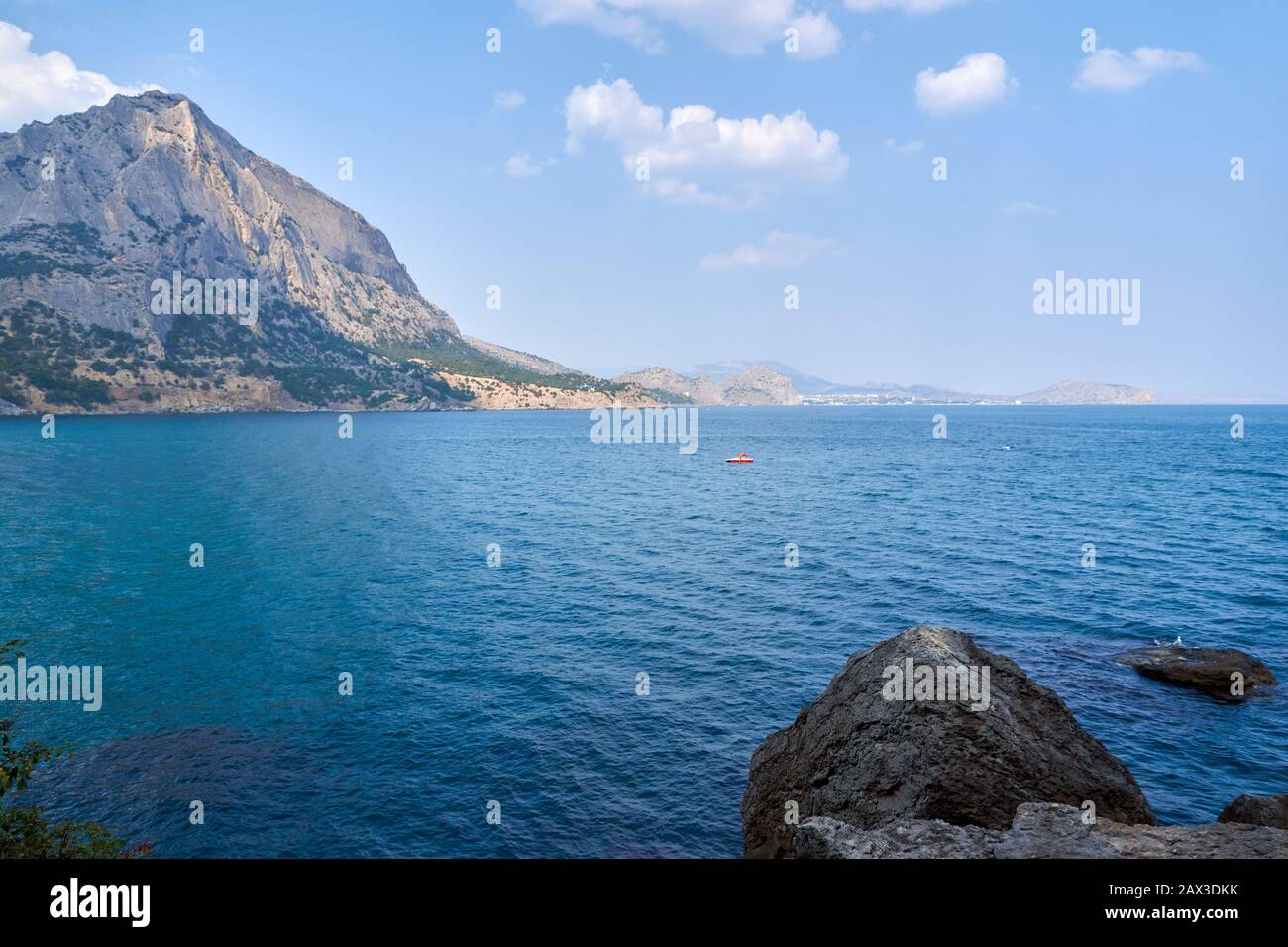 View of the Green Bay in the village of New World, coastal cliffs and a ...