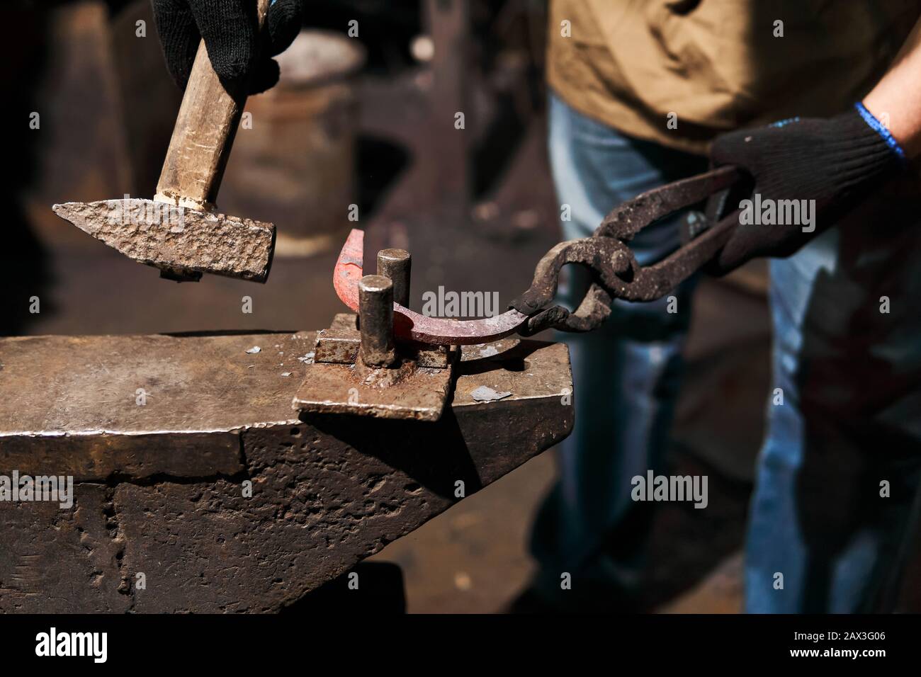 traditional forging of a hot metal billet on the anvil Stock Photo - Alamy