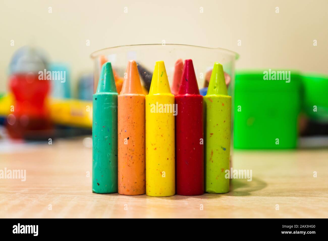 Colorful crayons on the ground in the kids' playing room Stock Photo ...