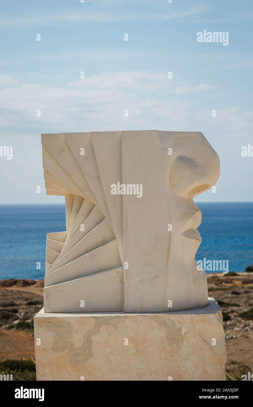 Vertical shot of the statue of the half of a man's face during daytime ...