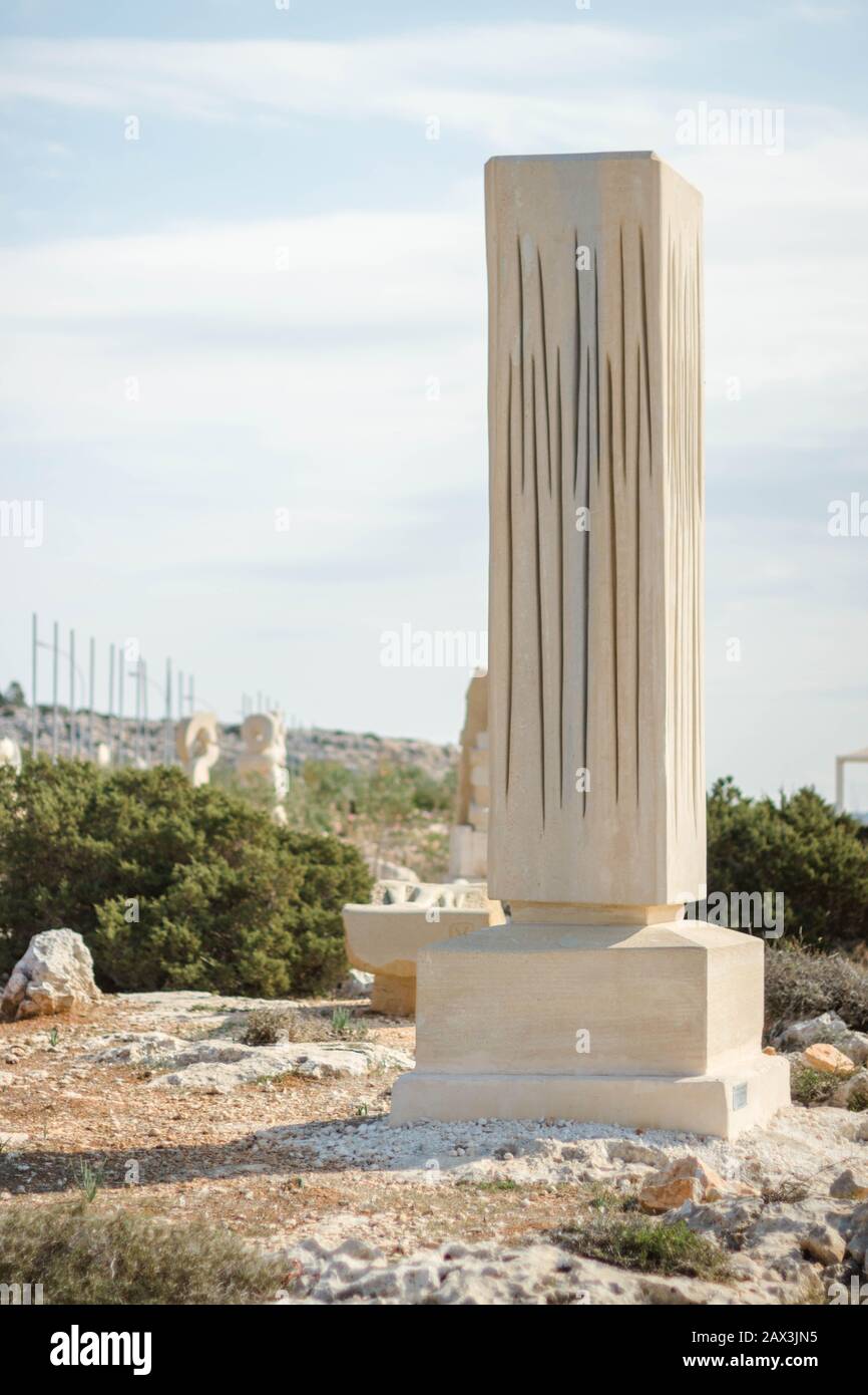 Vertical shot of a statue surrounded by bushes during daytime Stock ...