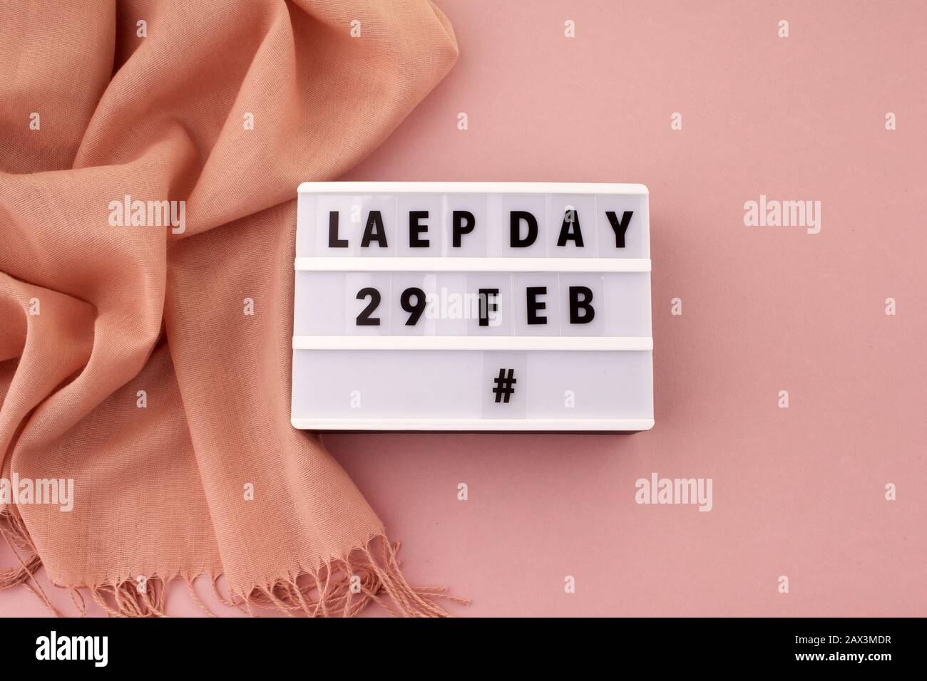 White block calendar present date 29 and month February and scarf on ...