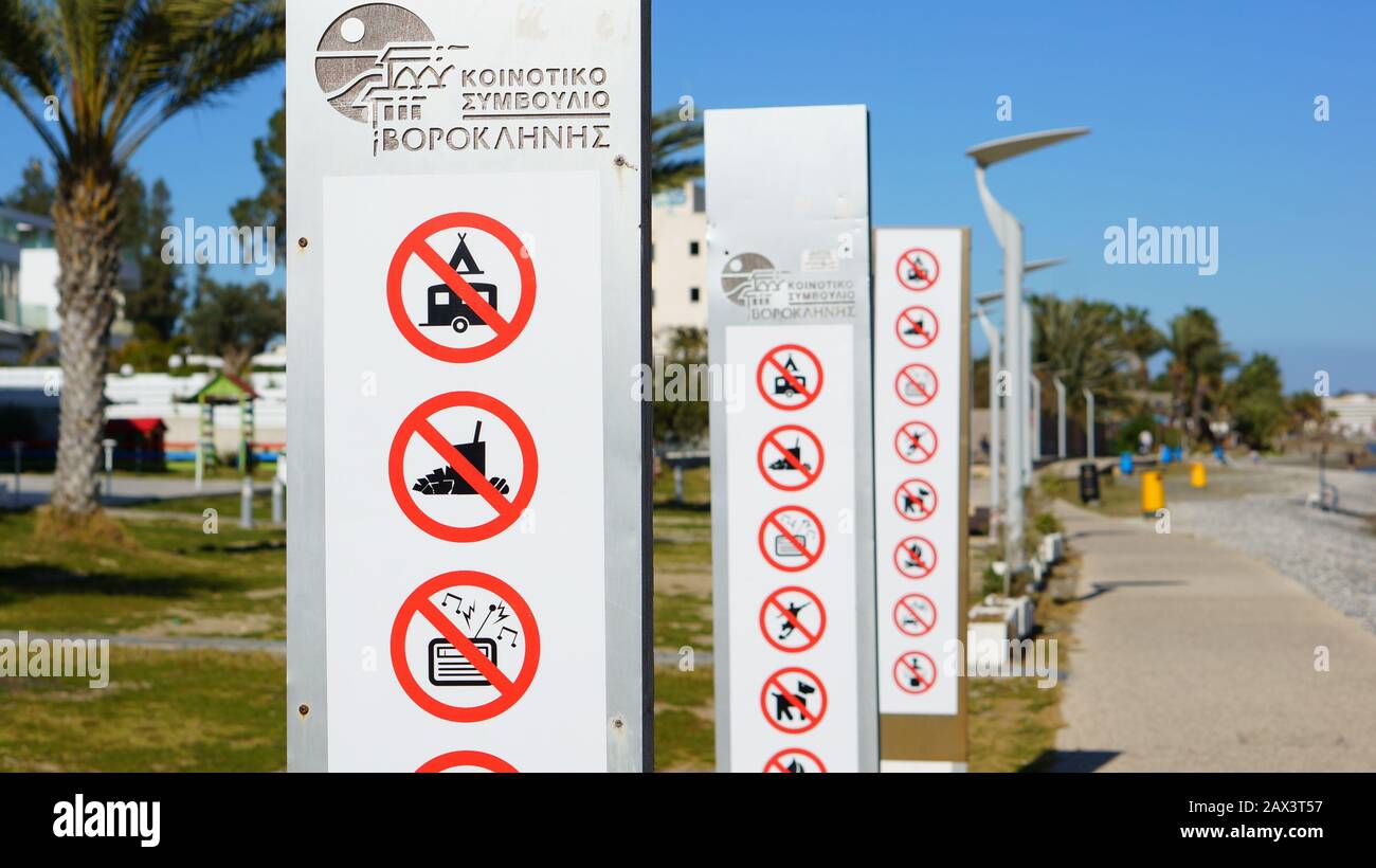 LARNAKA, CYPRUS - Mar 18, 2017: Row of signs with warning symbols by a ...