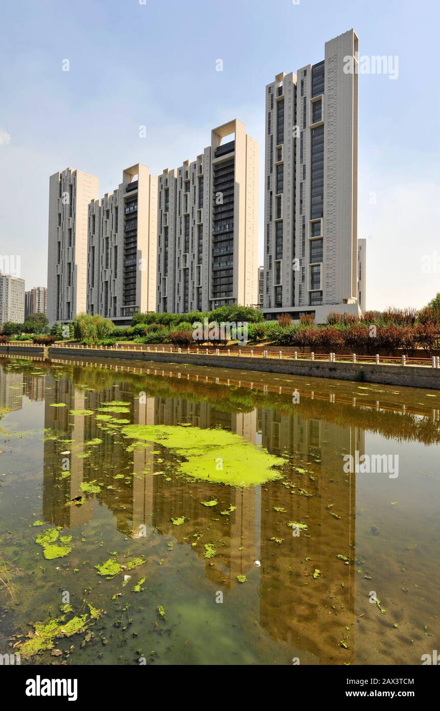 Channelised river by a new high-rise housing development with stagnant ...