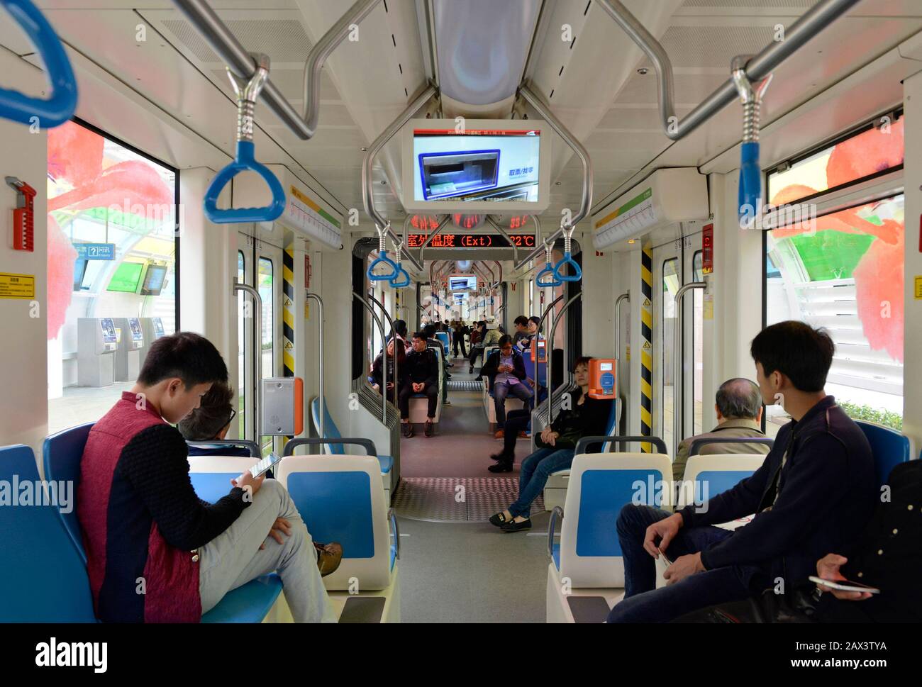 Passengers on a tram of the Haizhu tram system in Guangzhou, China ...