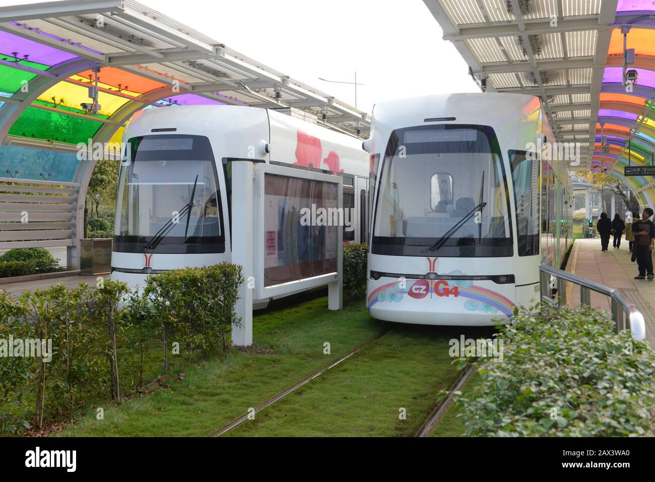 Two trams wait at a station on the Haizhu tram system in Guangzhou ...