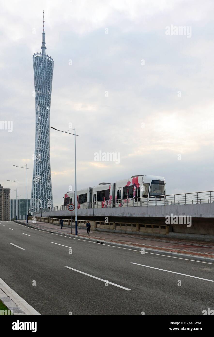A tram travels on the Haizhu tram line near the Canton Tower in eastern ...