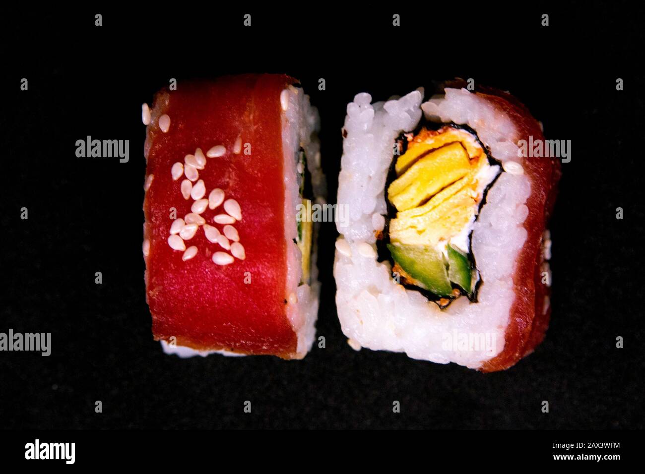 Roll maguro isolated on a black background Stock Photo - Alamy