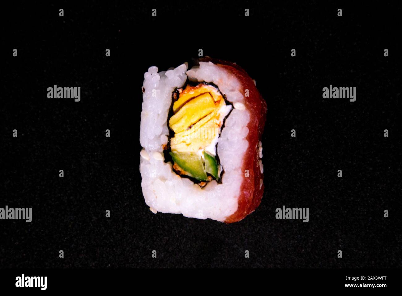 Roll maguro isolated on a black background Stock Photo - Alamy